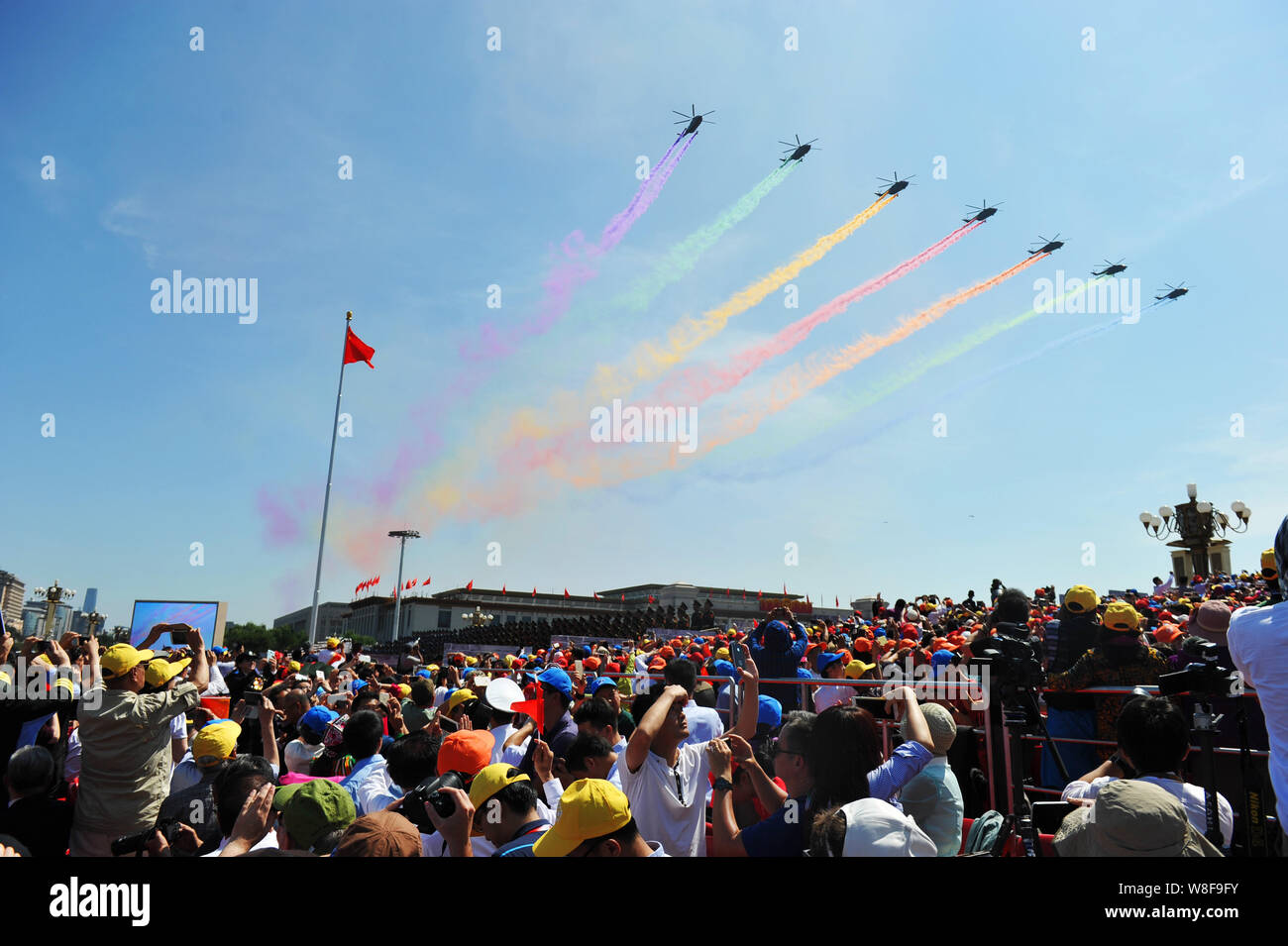 Military helicopters fly in formation over Tiananmen Square during the ...
