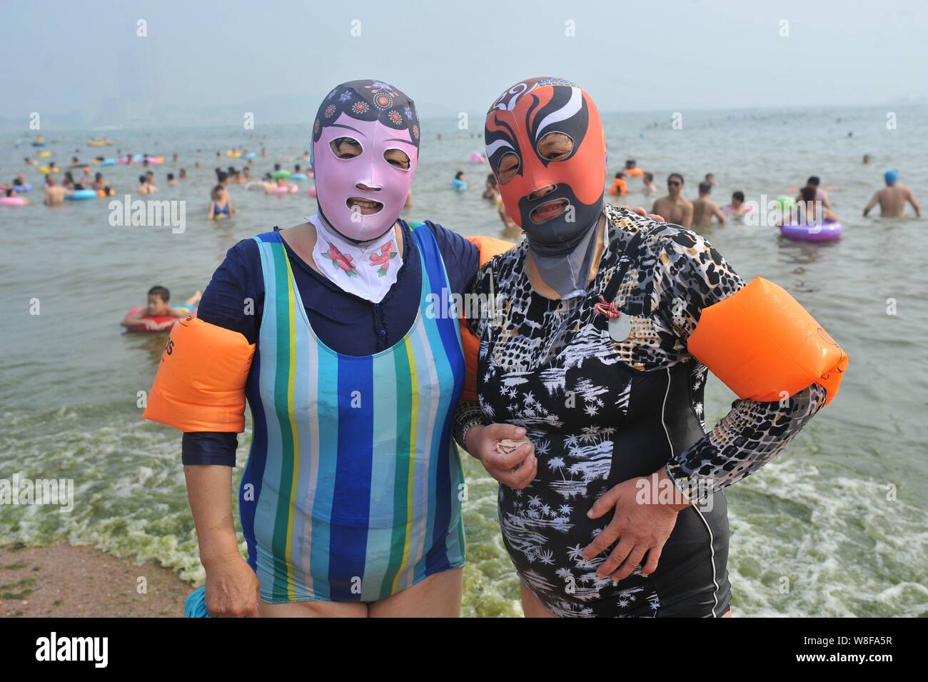 Female Chinese swimmers wearing facekinis featuring designs of ...