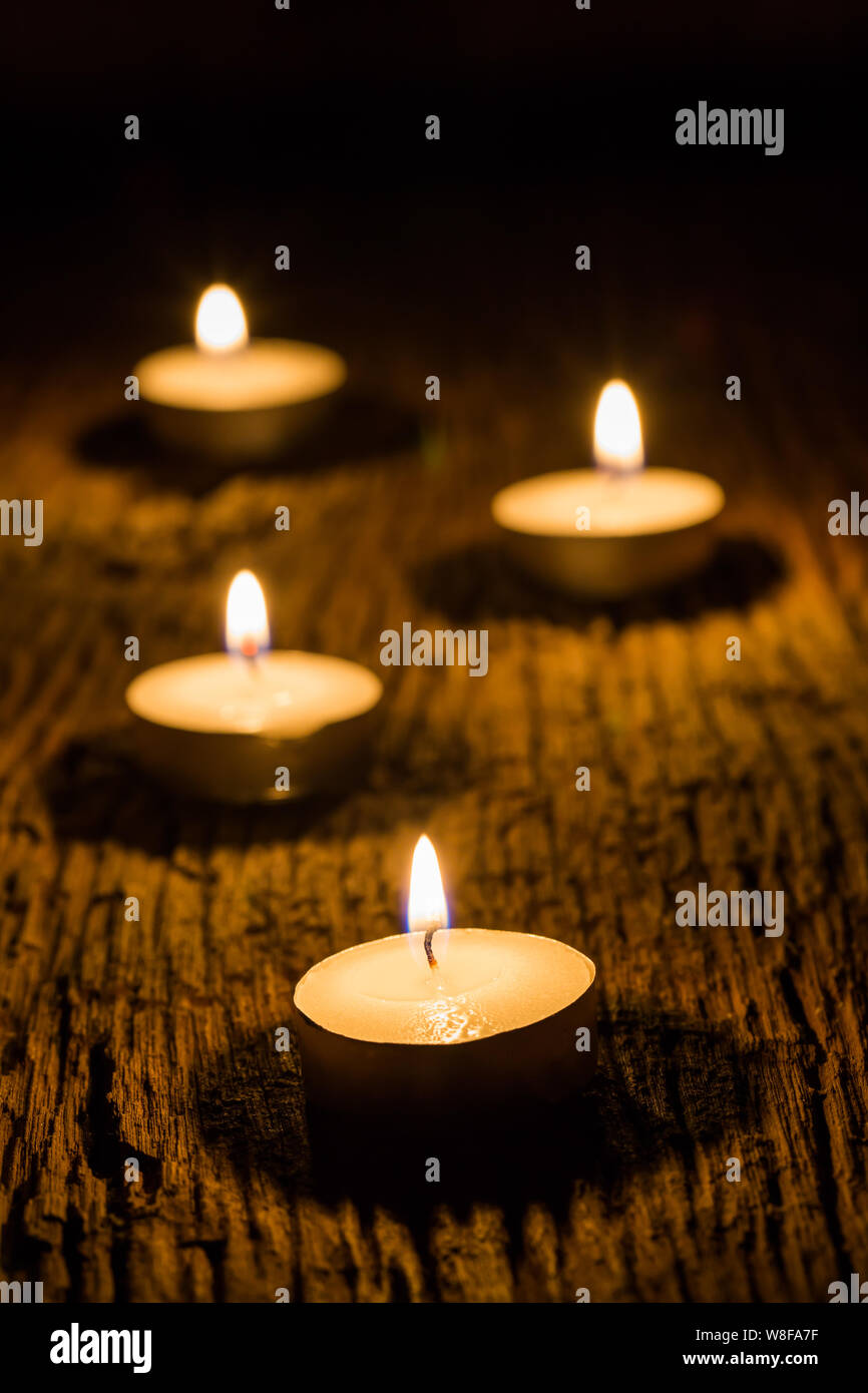candle light in dark on wood texture Stock Photo - Alamy
