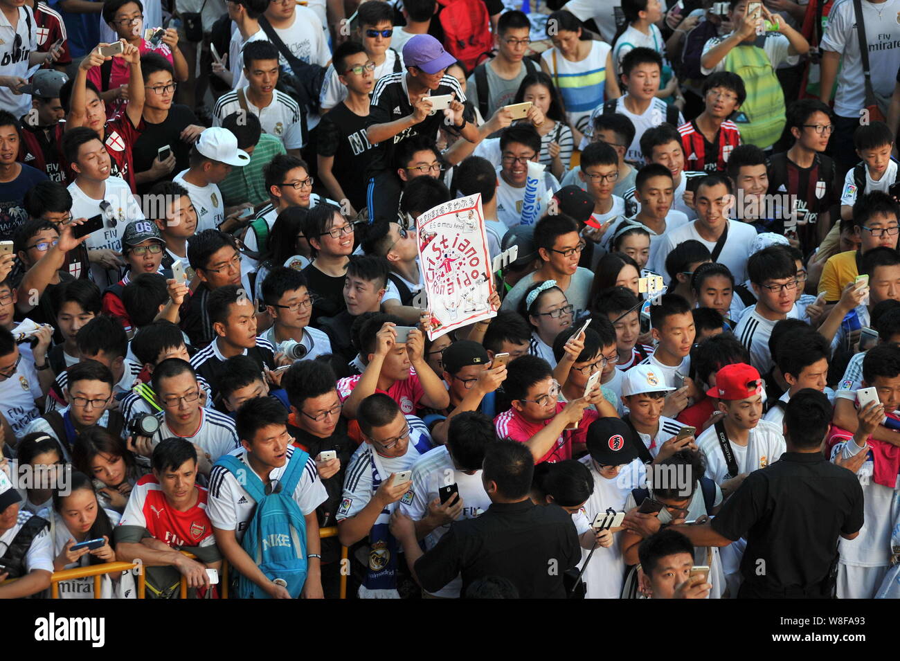 A crowd of football fans wait for the arrival of players of Real Madrid ...