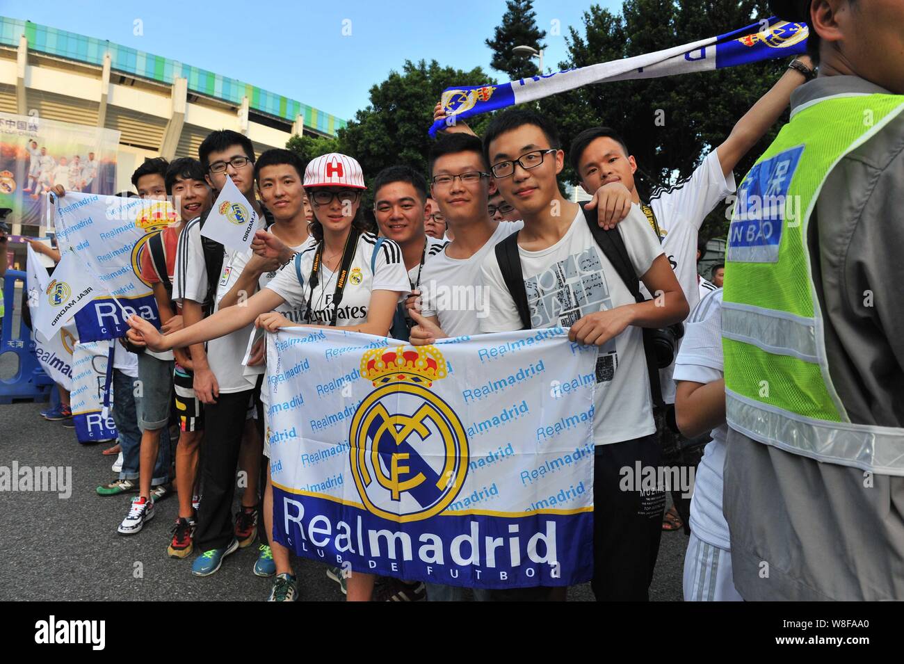Chinese football fans hold flags of Real Madrid ahead of a soccer match ...