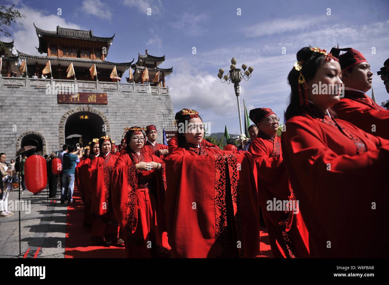 Couples of newlyweds dressed in Chinese Han costumes parade during a ...