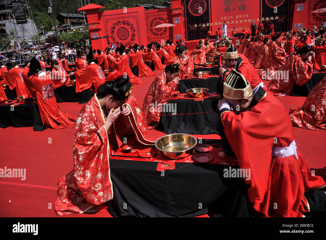 Couples of newlyweds dressed in Chinese Han costumes take part in a Han ...