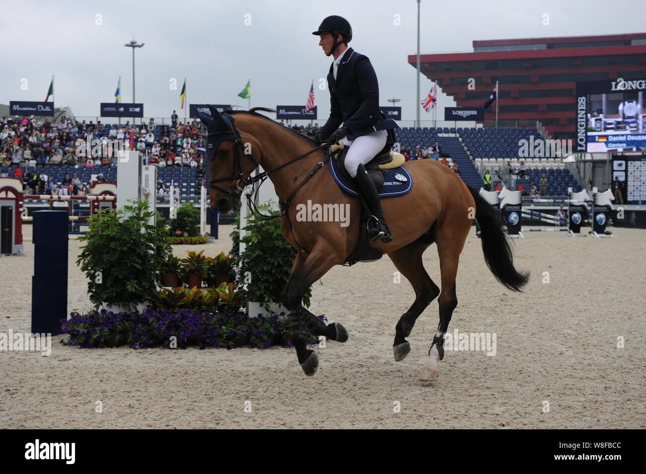 An equestrian rider competes in the Against the Clock during the ...