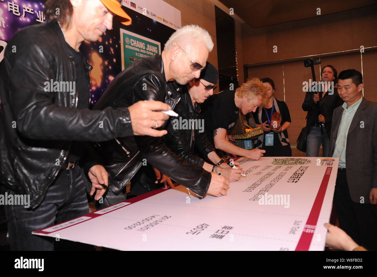 Members of German rock band Scorpions sign their autographs during a ...