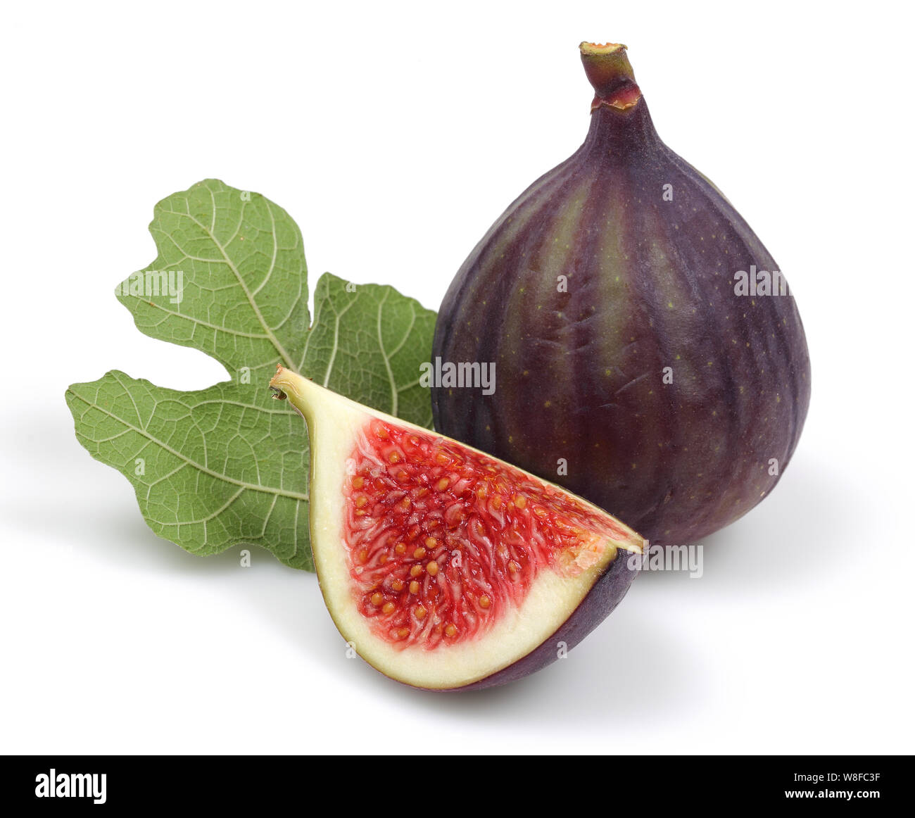 Fresh purple fig fruit and slice with leaf isolated on white background ...