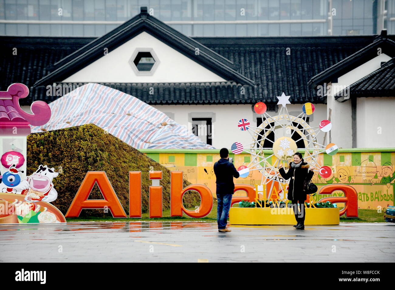 --FILE--People take photos in front of the headquarters of Chinese e ...