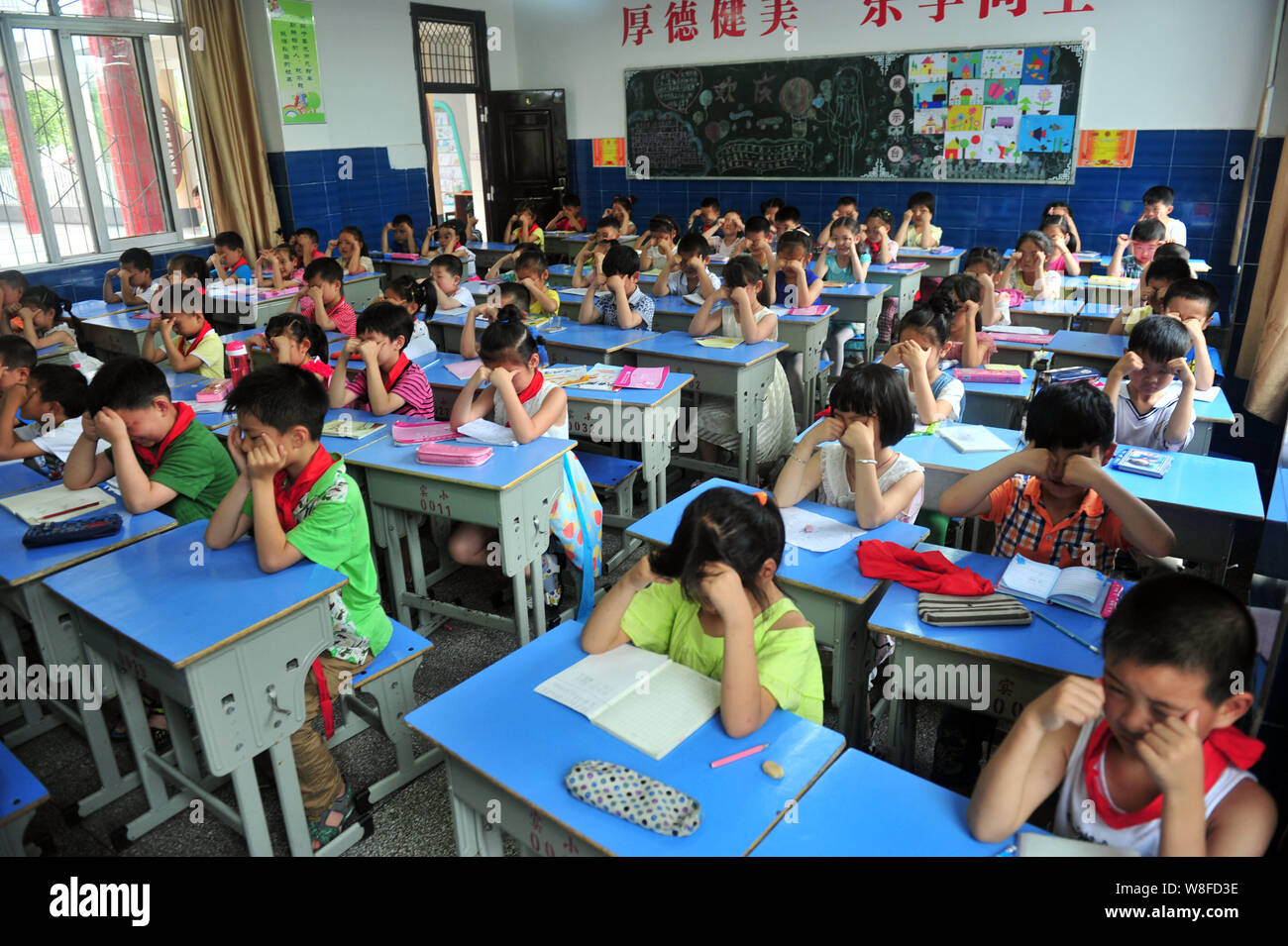 --FILE--Chinese students perform daily acupressure eye exercises in a ...