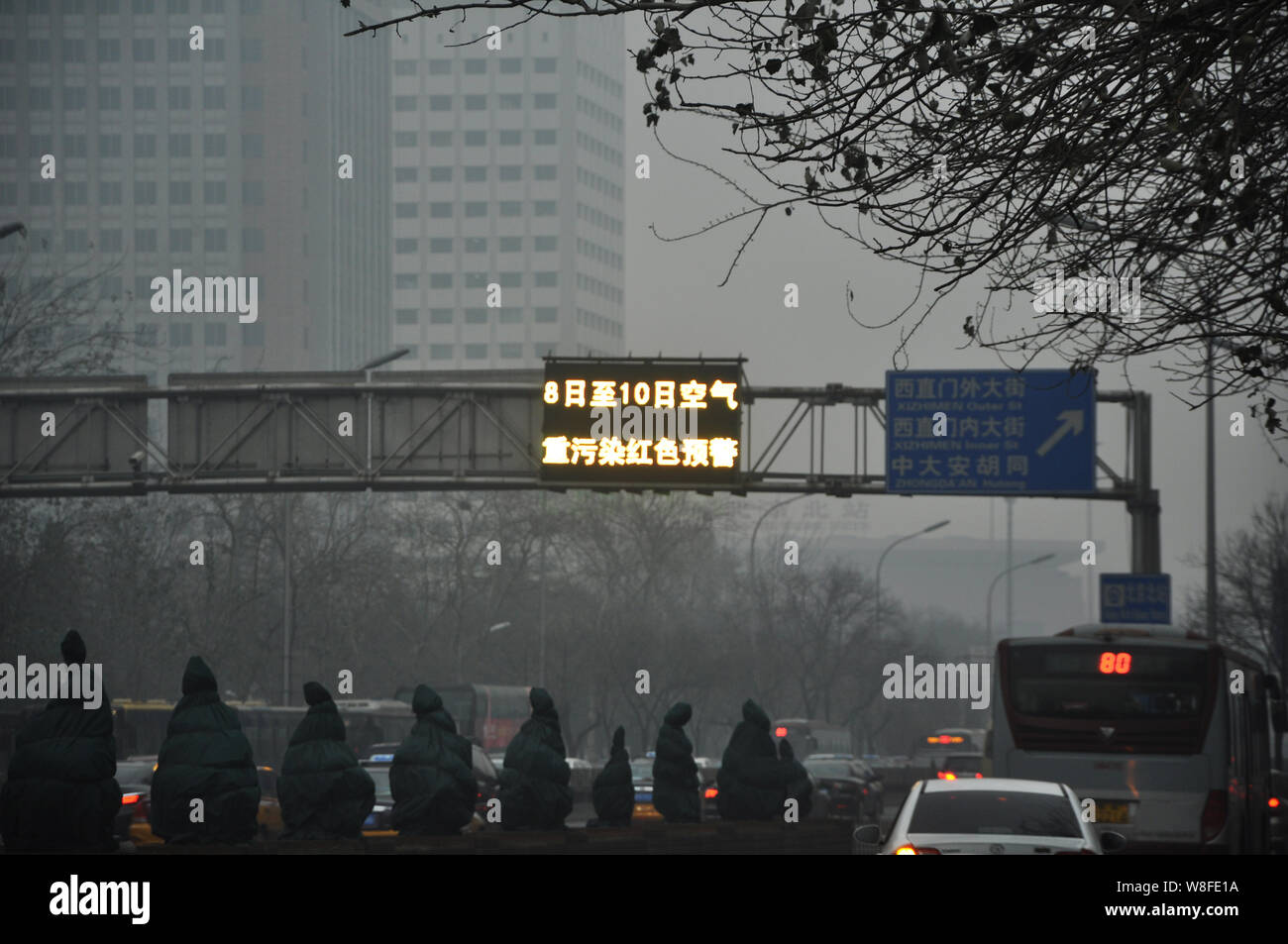 View of a board showing red alert for air pollution on a road in heavy ...
