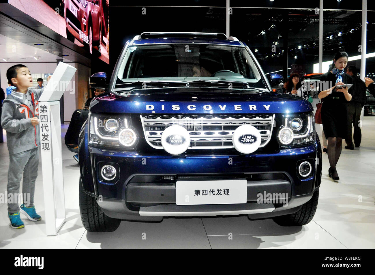 --FILE--Visitors try out a Land Rover Discovery on display during the ...