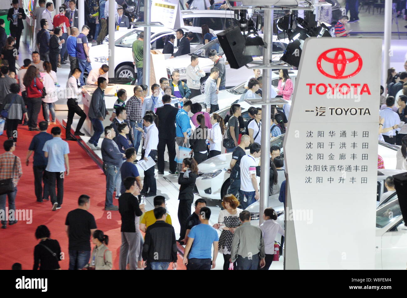 --FILE--Visitors look at Toyota cars on display during an auto show in ...