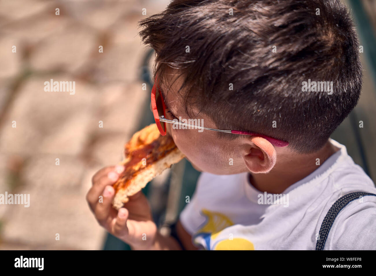 Little boy eating pizza Stock Photo - Alamy