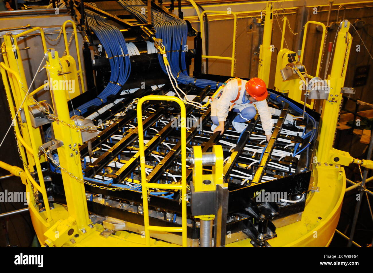 --FILE--A Chinese technician lays cables on a nuclear reactor built ...