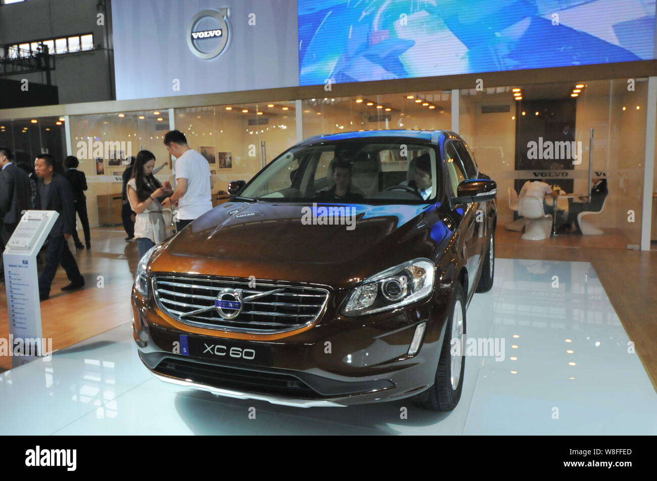 --FILE--Visitors try out a Volvo XC60 during an automobile exhibition ...