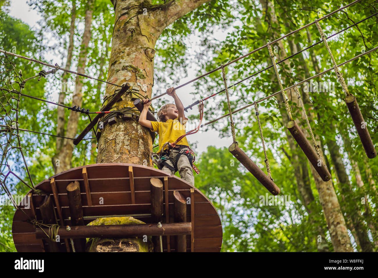 Little boy in a rope park. Active physical recreation of the child in ...