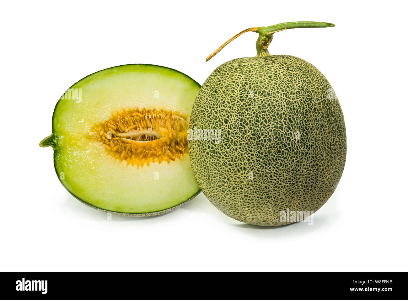 Fresh green melons sliced on wooden table over white background Stock ...