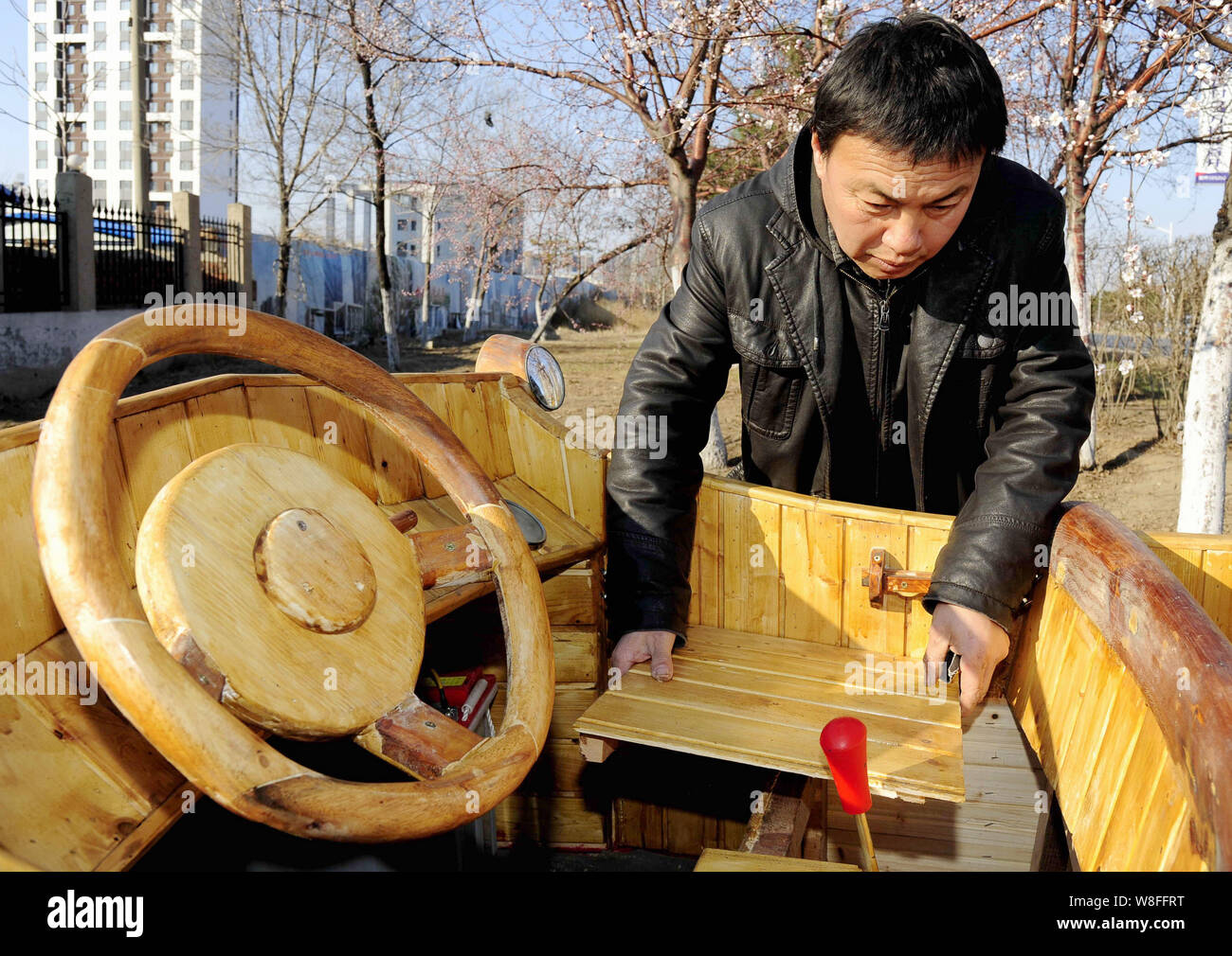 Chinese carpenter Liu Fulong checks the seat of his third homemade ...