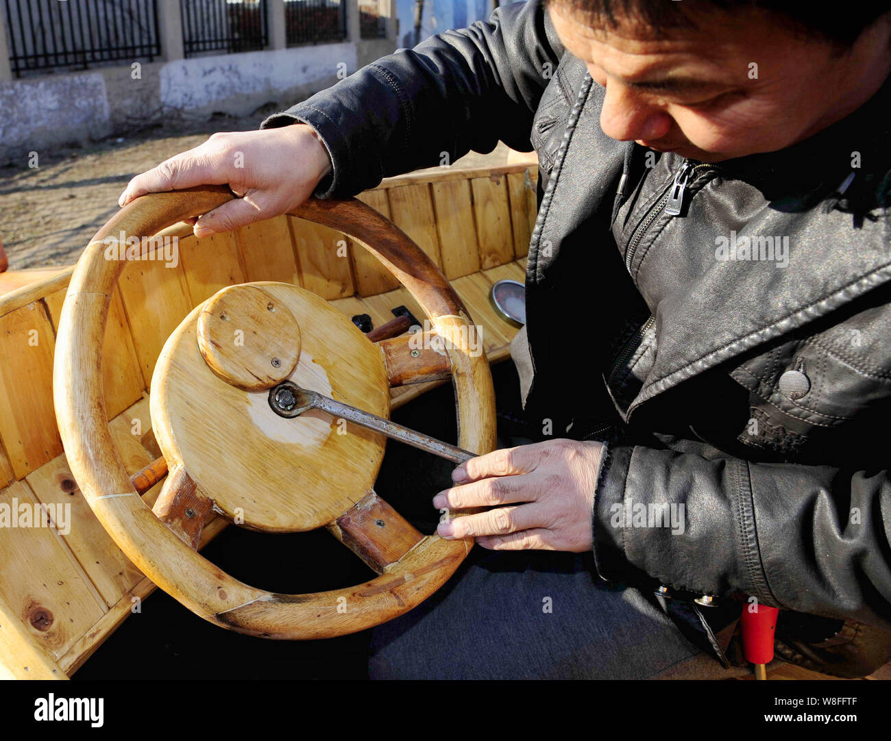 Chinese carpenter Liu Fulong installs the steering wheel on his third ...