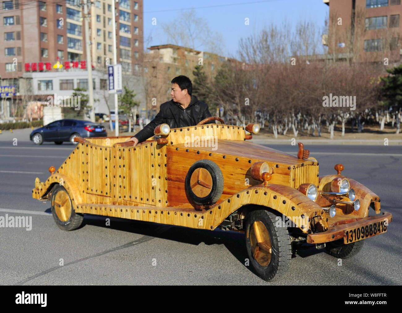Chinese carpenter Liu Fulong test-drives his third homemade wooden ...