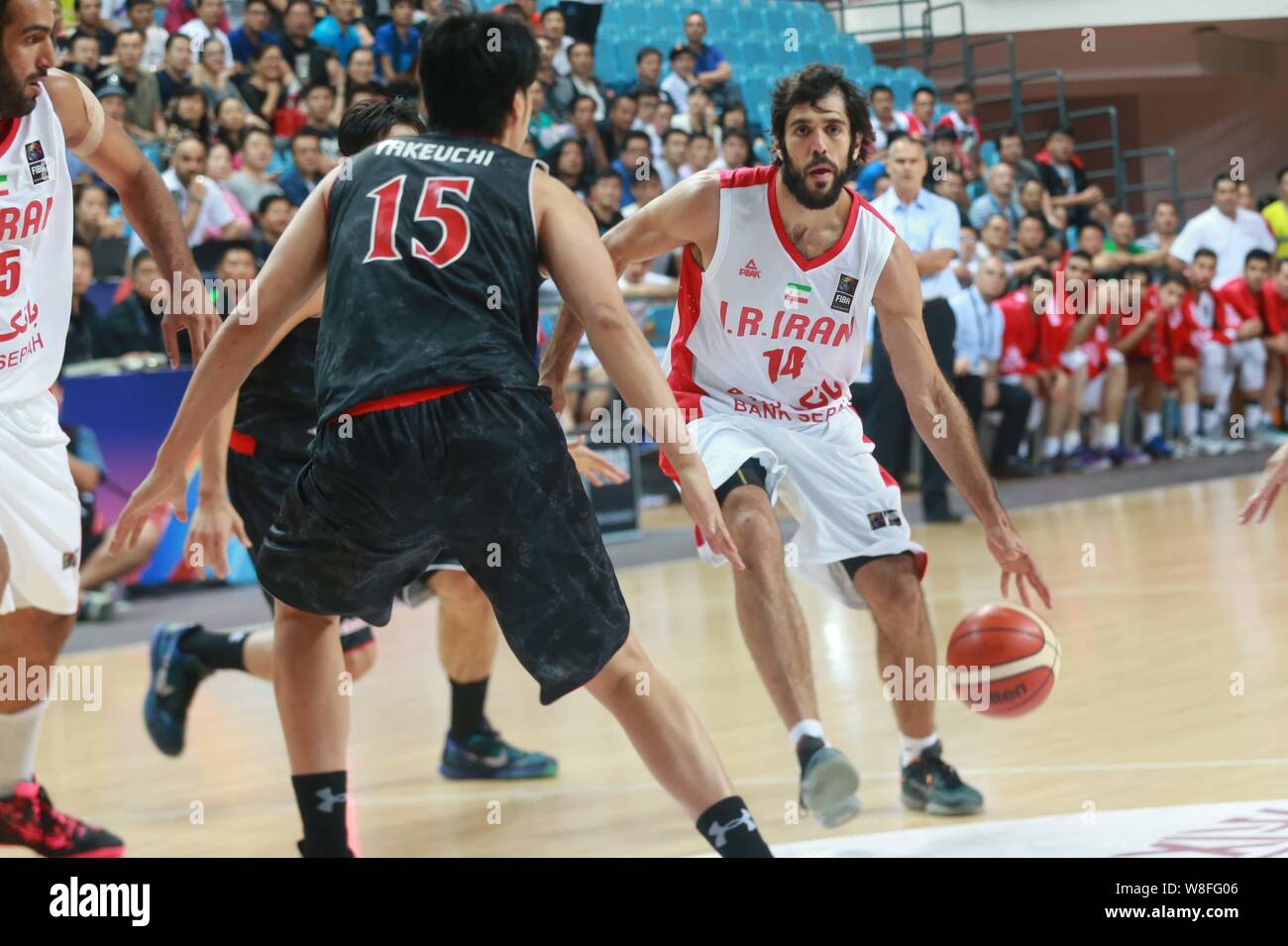 Joji Takeuchi of Japan, left, challenges Mohammadsamad Nik Khahbahrami ...