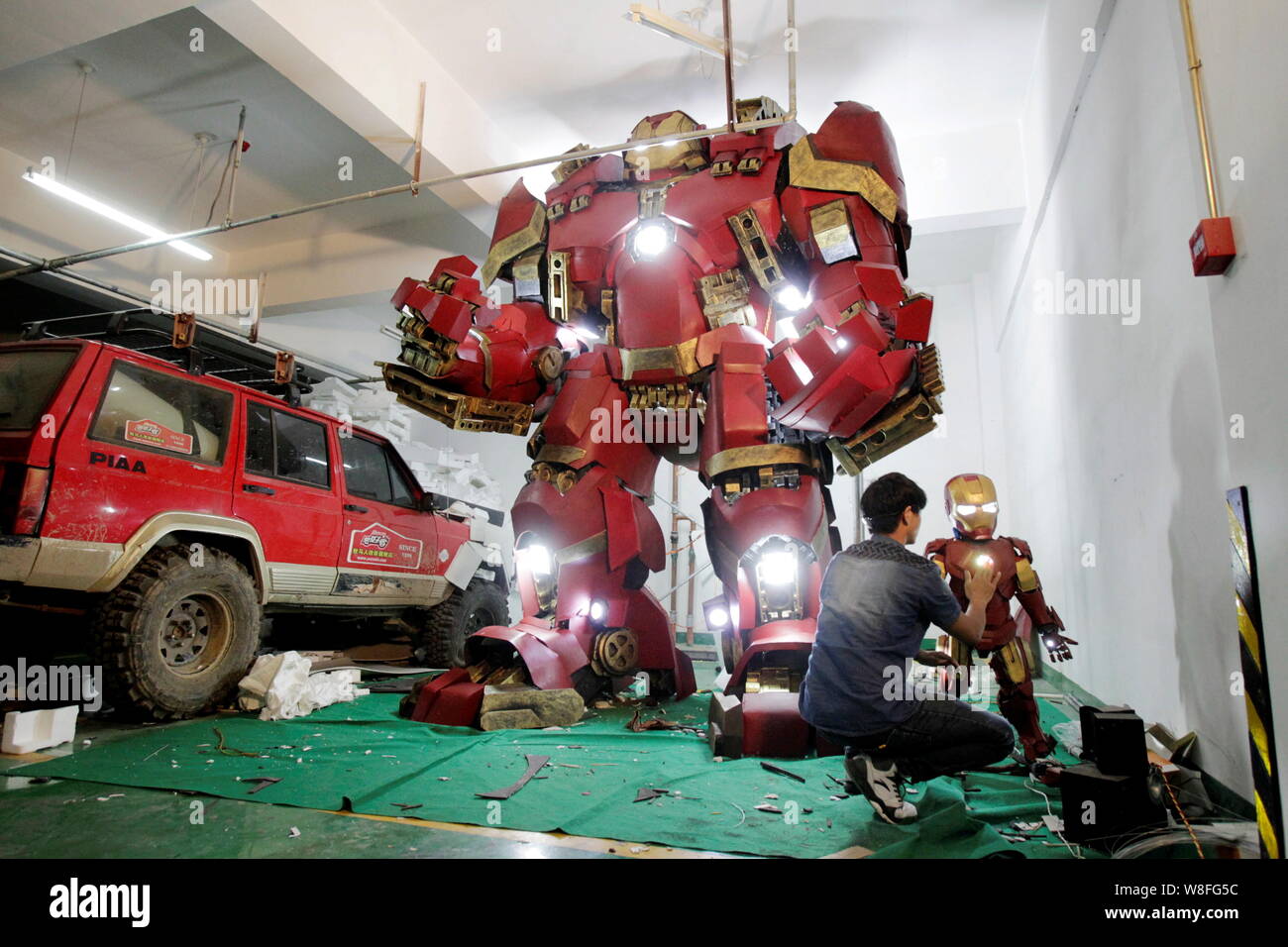 An assistant of Chinese fine arts teacher Xing Yile tests the models of ...
