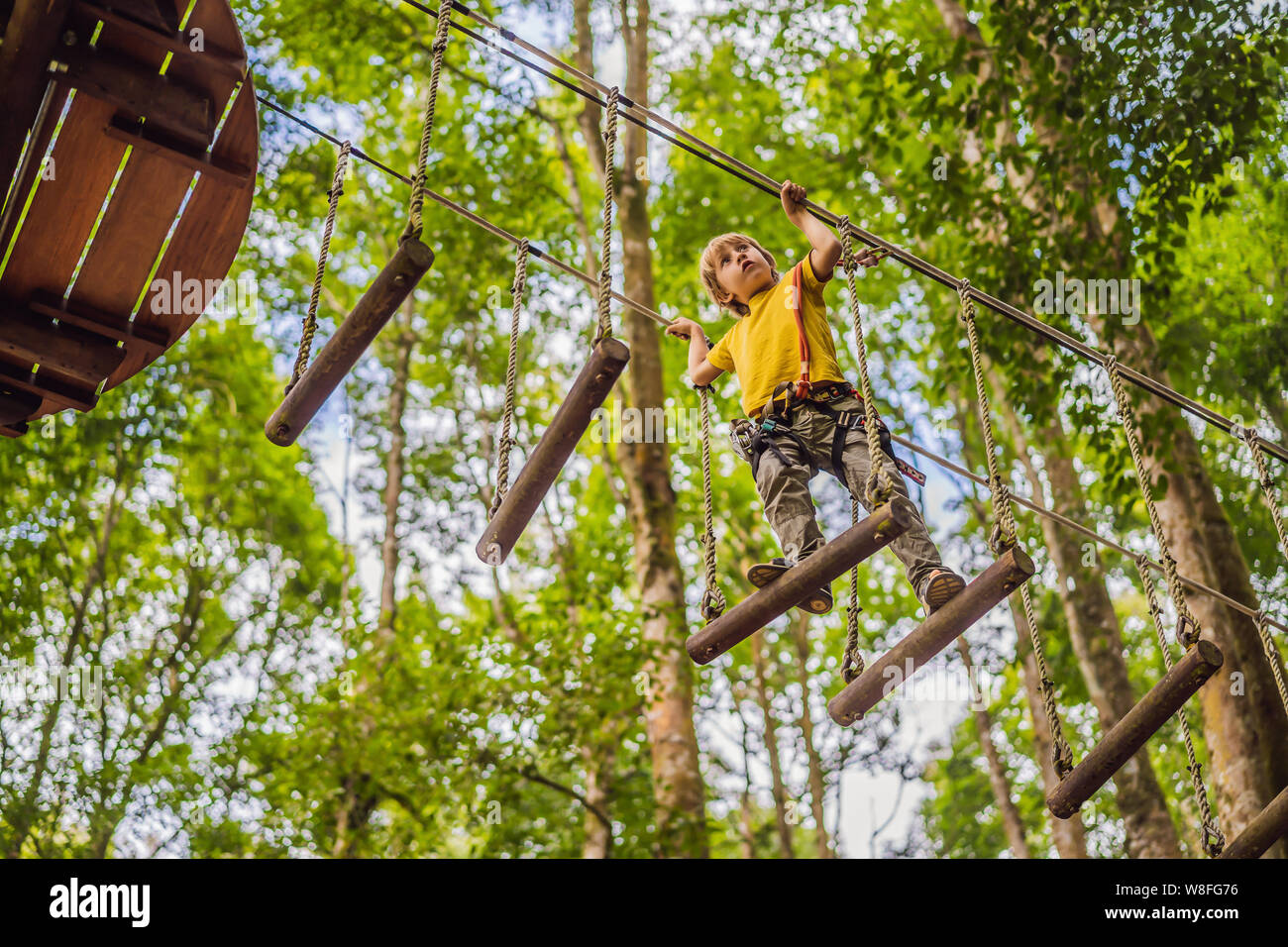 Little boy in a rope park. Active physical recreation of the child in ...