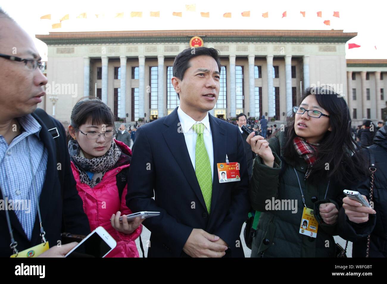 Robin Li Yanhong, center, Chairman and CEO of Baidu, is interviewed as ...