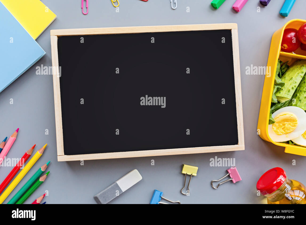 School supplies and lunch box with sandwich and vegetables. Back to ...