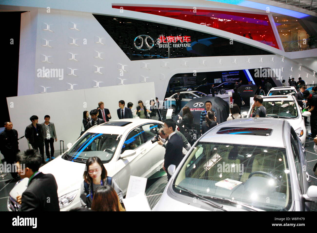 --FILE--Visitors look at cars of BAIC Motor on display during the 13th ...