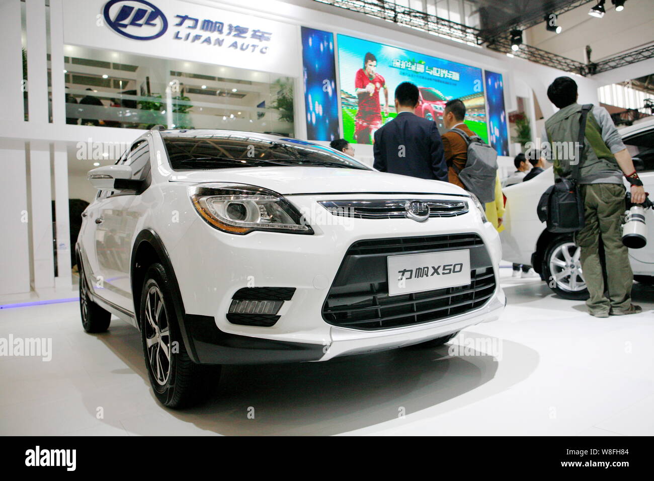 --FILE--Visitors look at cars of Lifan Auto on display during the 13th ...