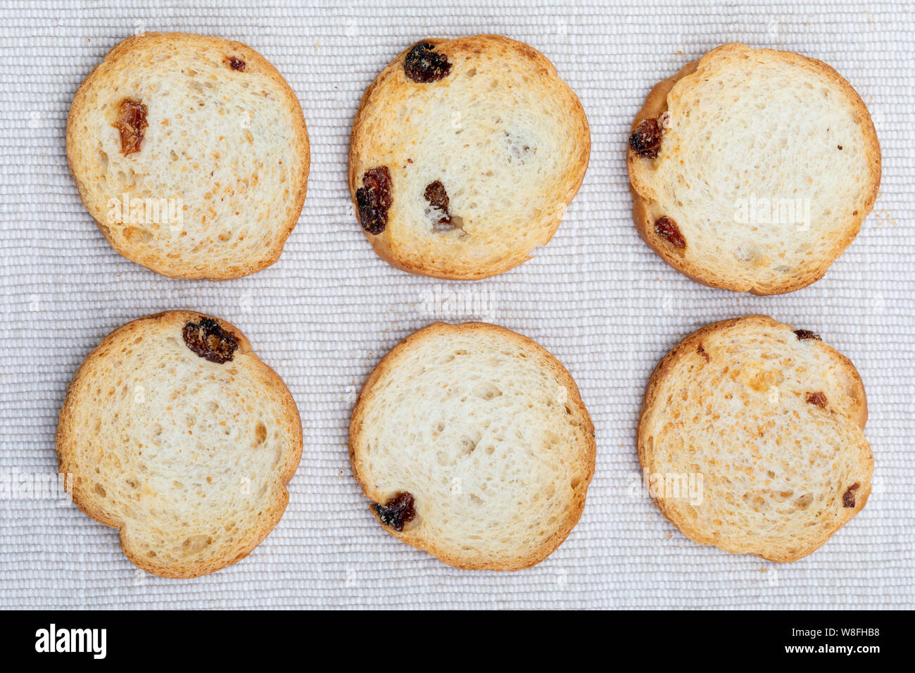 Mini round toasts of bread with raisins. 6 units. On delicate fabric ...