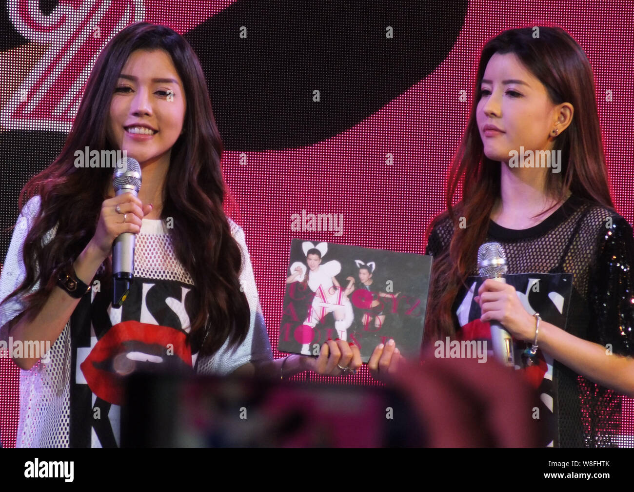 The twin sisters Miko and Yumi of Singaporean pop duo BY2 attend a ...