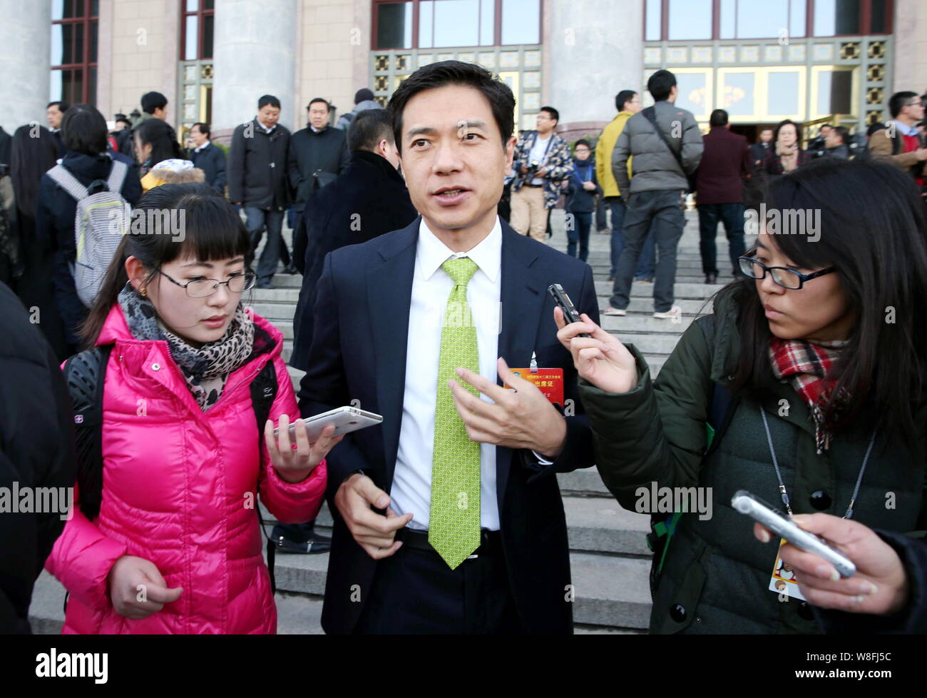 Robin Li Yanhong, center, Chairman and CEO of Baidu, is interviewed as ...