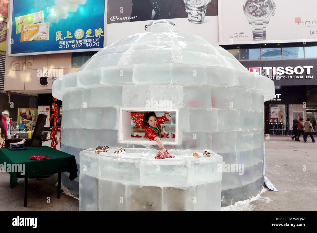 A Chinese waitress prepares sticks of sugar-coated haws inside the ...