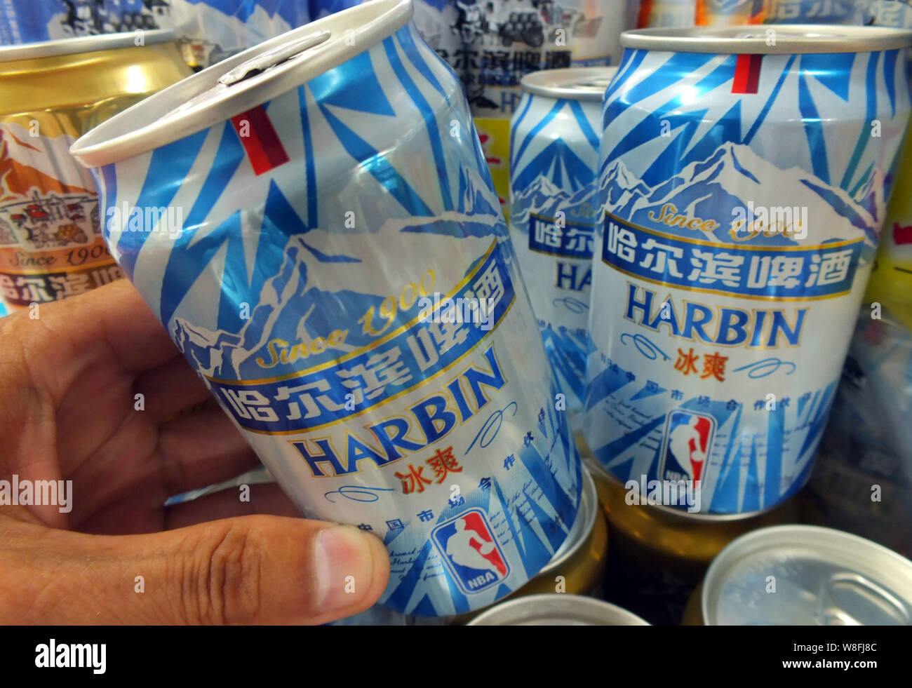 --FILE--A customer buys a can of Harbin Beer of Anheuser-Busch InBev ...