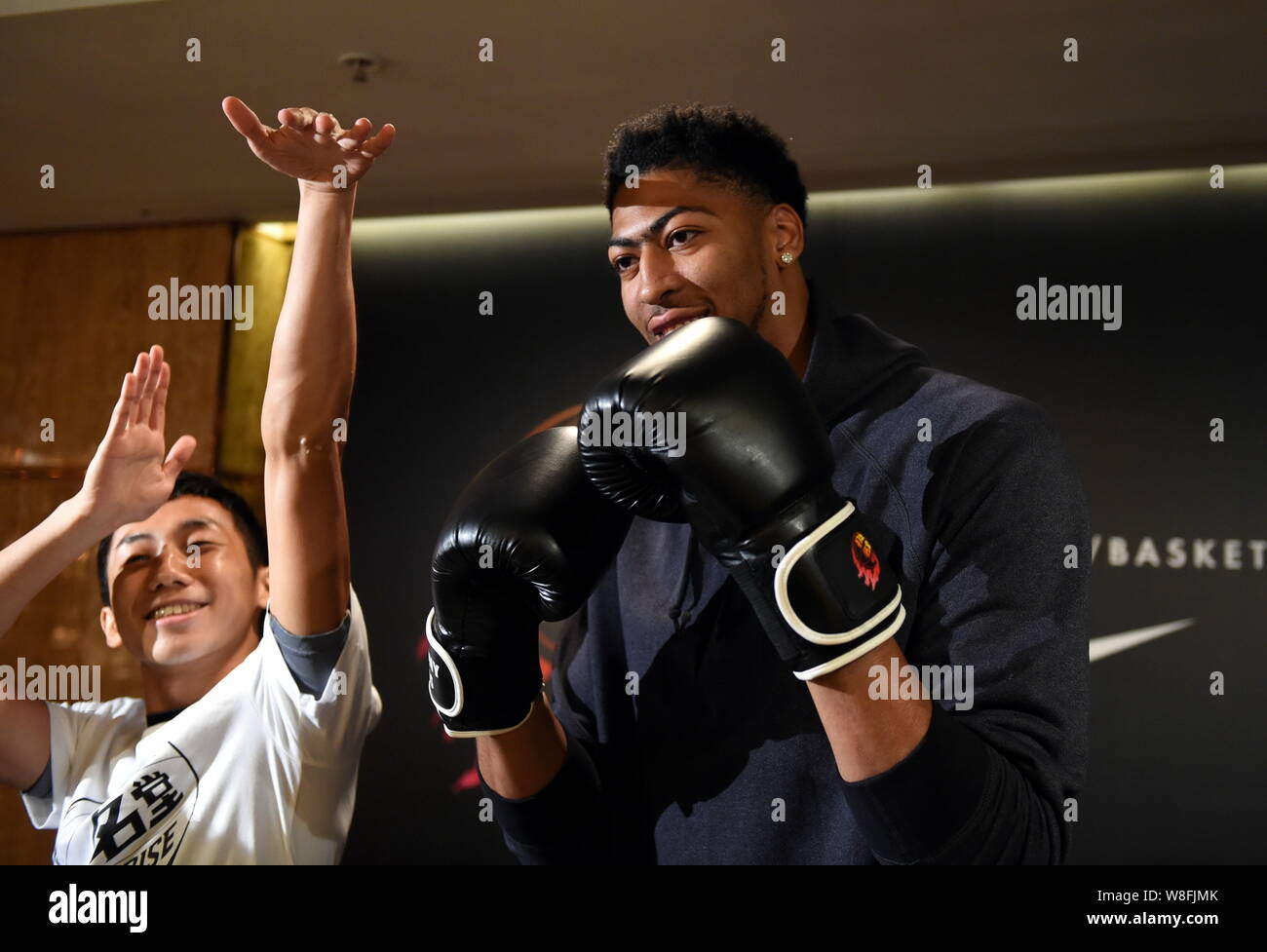 NBA star Anthony Davis, right, wearing boxing gloves poses with Hong ...