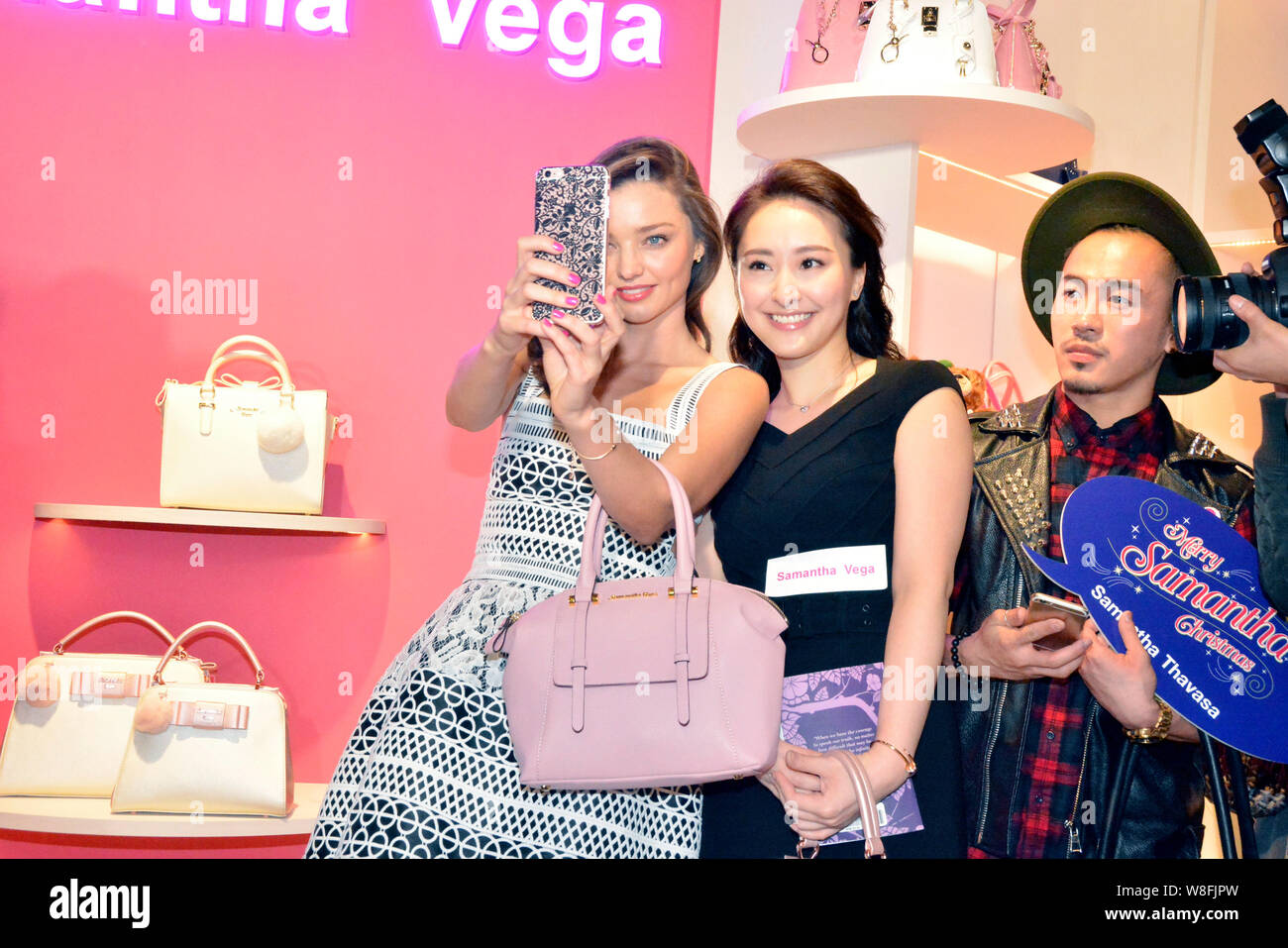 Australian model Miranda Kerr, left, takes a selfie with Hong Kong ...