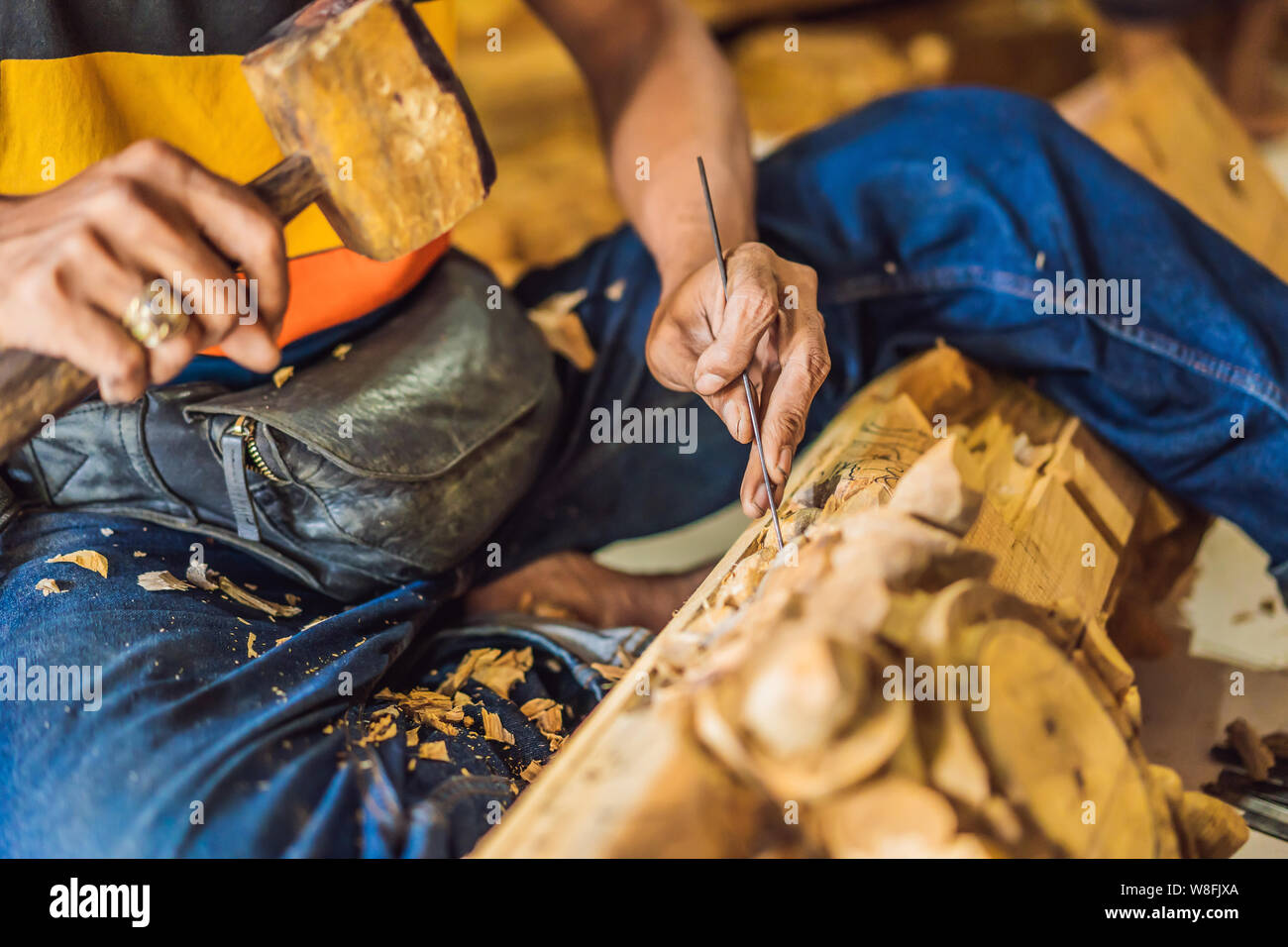 Master wood-carver made using a special knife wooden national dish - a ...
