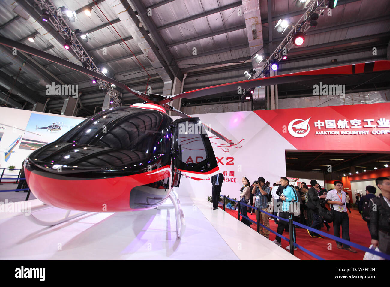 --FILE--Visitors look at a helicopter on display at the stand of AVIC ...
