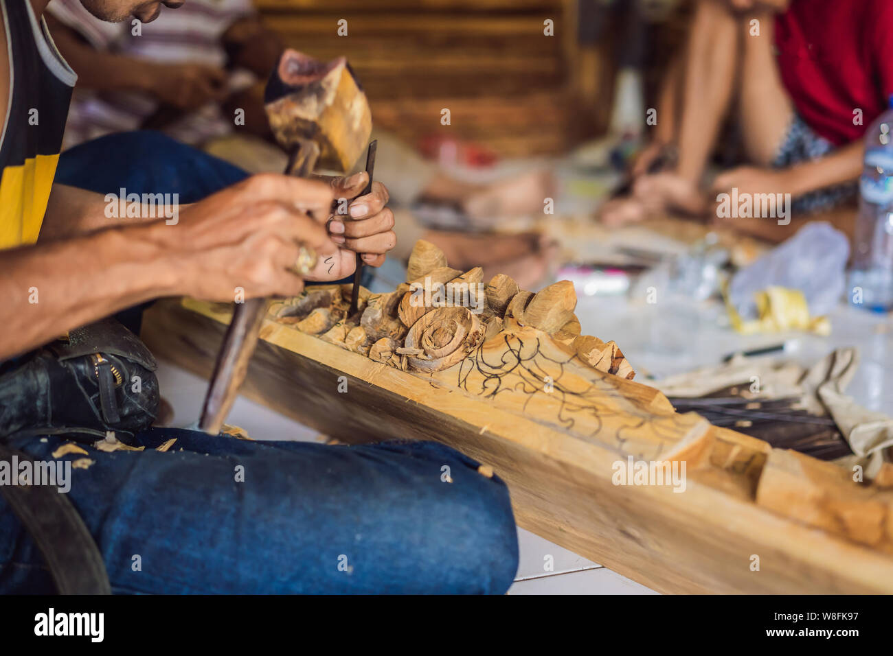 Master wood-carver made using a special knife wooden national dish - a ...