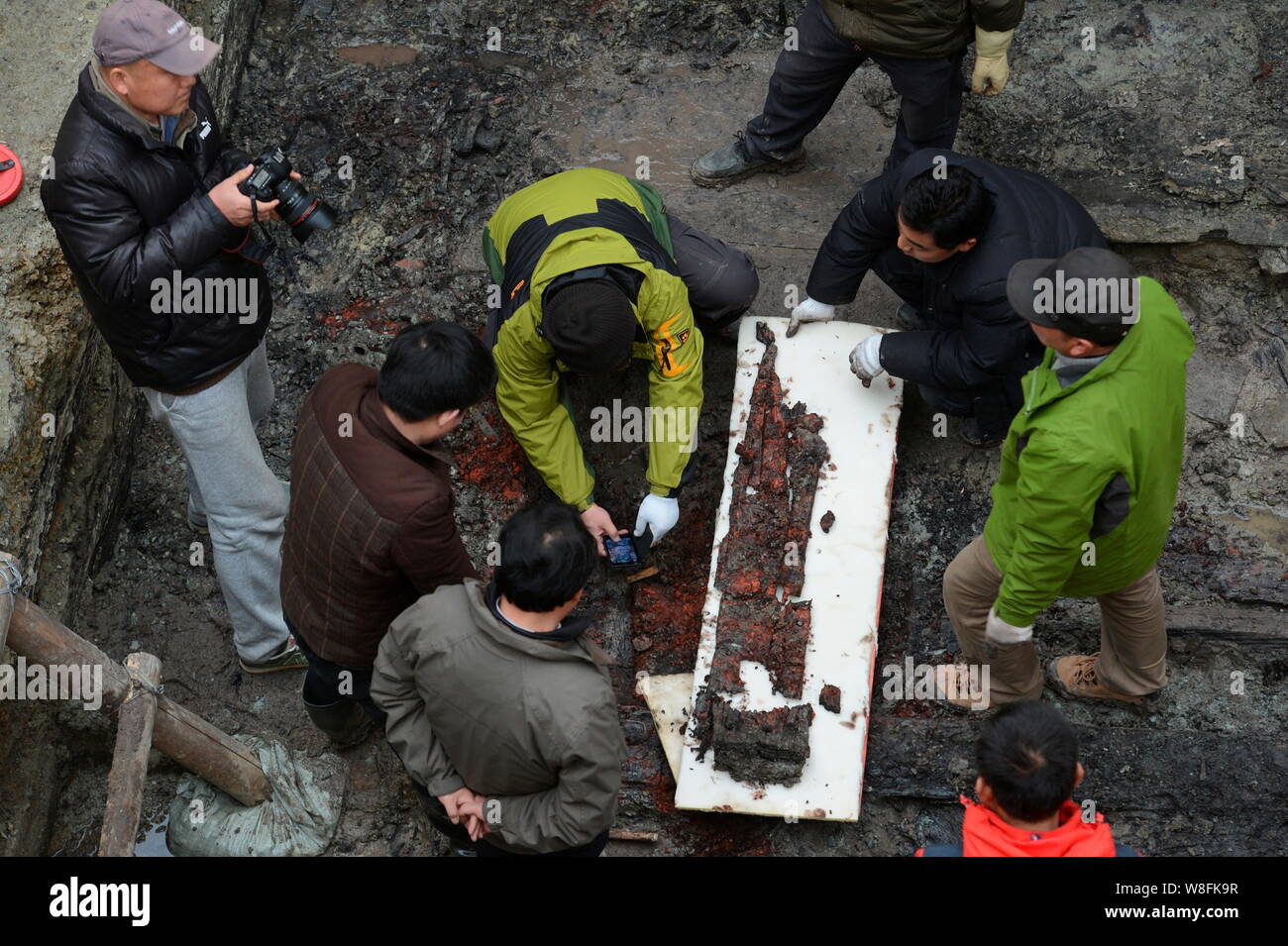 Archaeologists survey a broken Se, a 25-string ancient Chinese musical ...