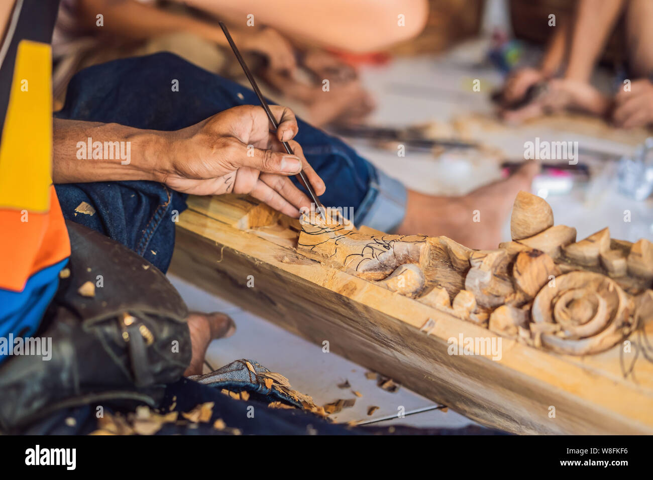 Master wood-carver made using a special knife wooden national dish - a ...