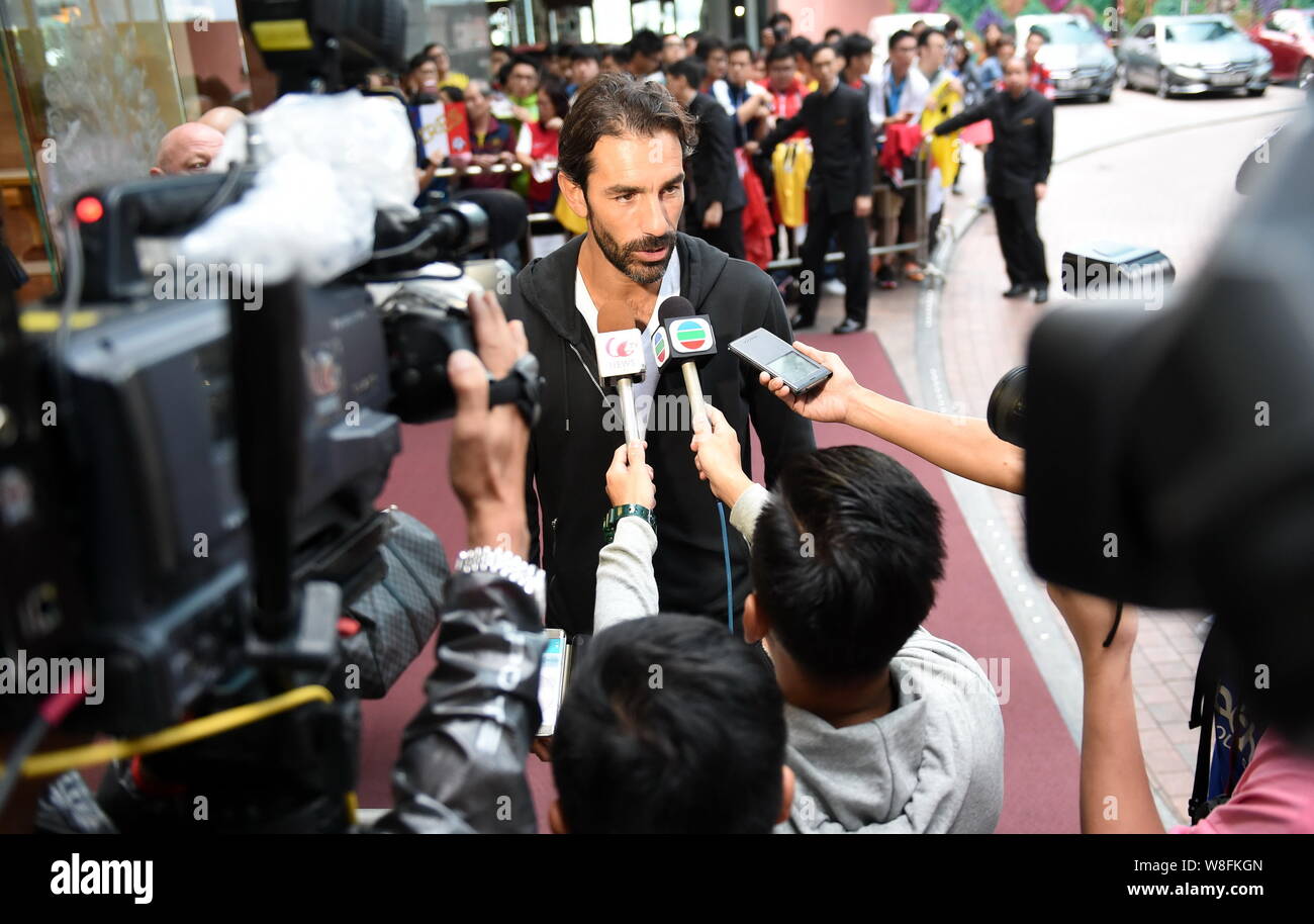 Former French soccer player Robert Pires, back, is interviewed after ...