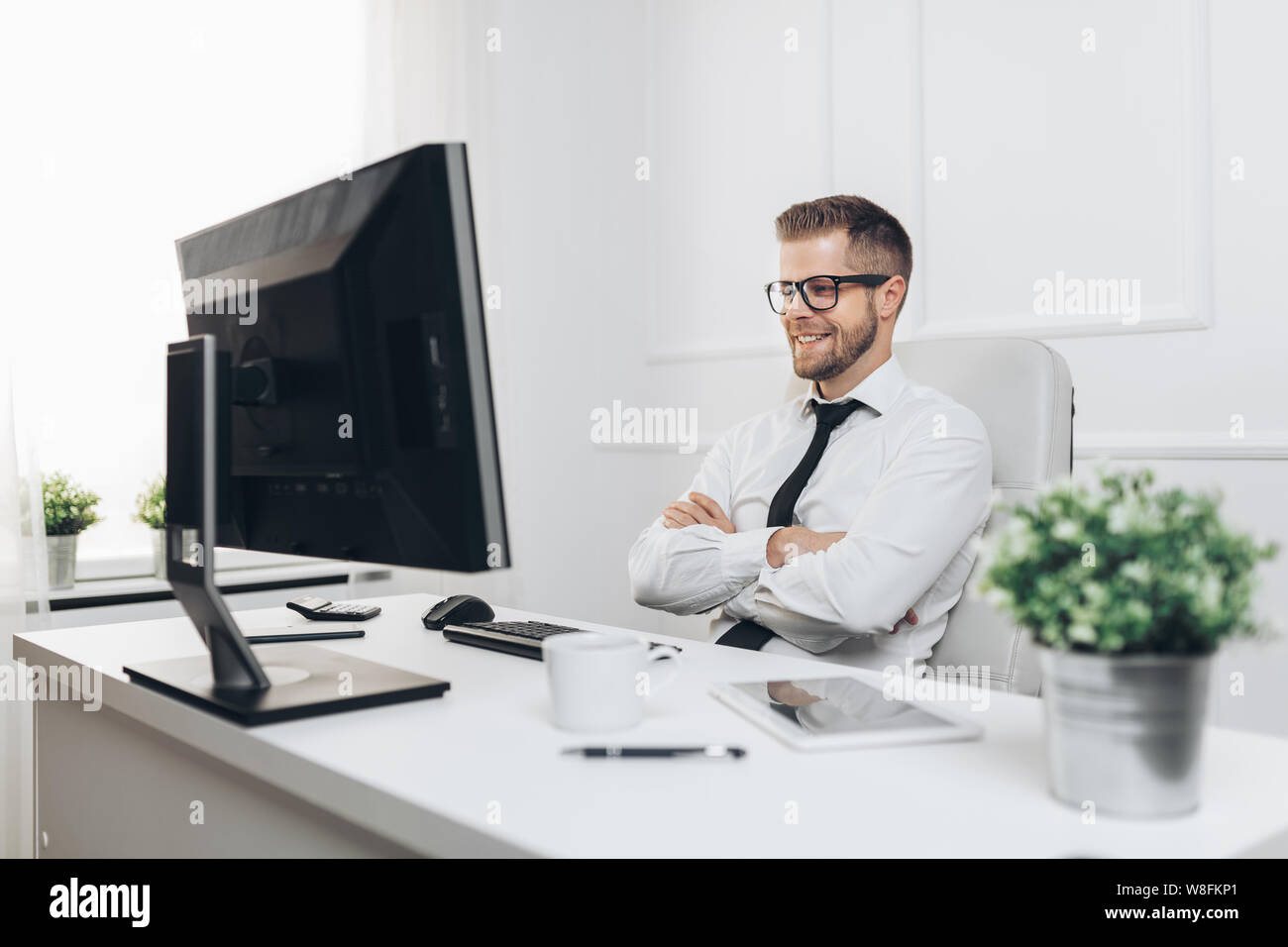 Successful handsome businessman working in his office Stock Photo - Alamy