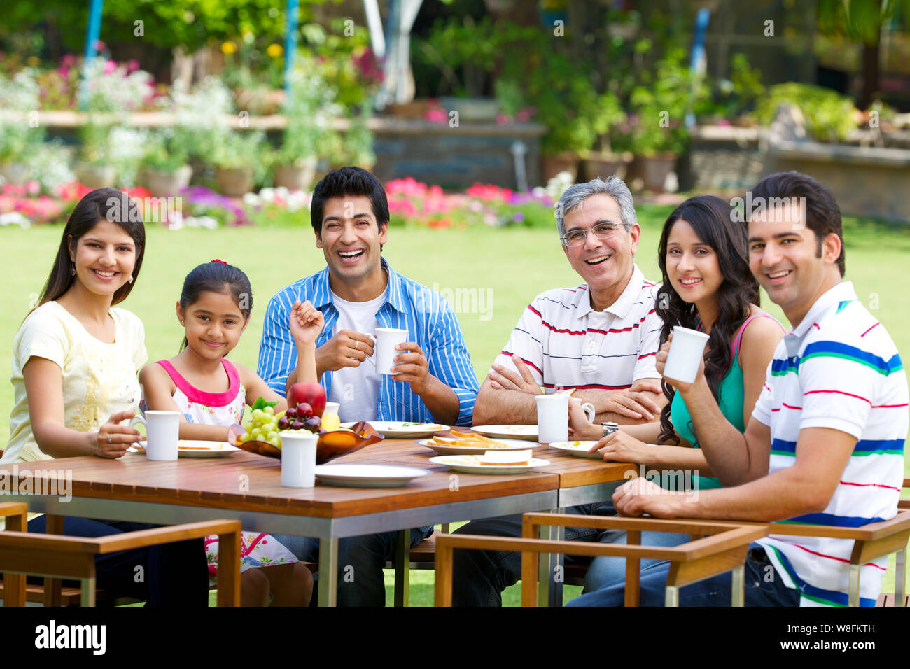 Family having breakfast in lawn Stock Photo - Alamy