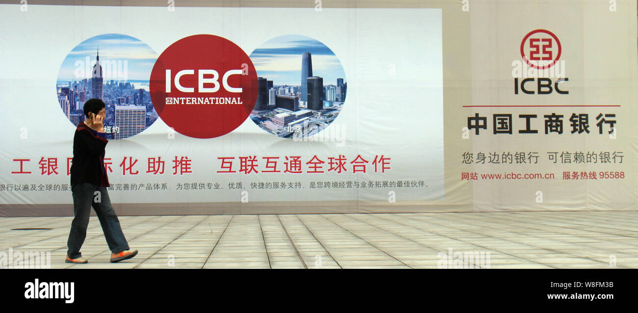 --FILE--A pedestrian walks past an advertisement for ICBC (Industrial ...