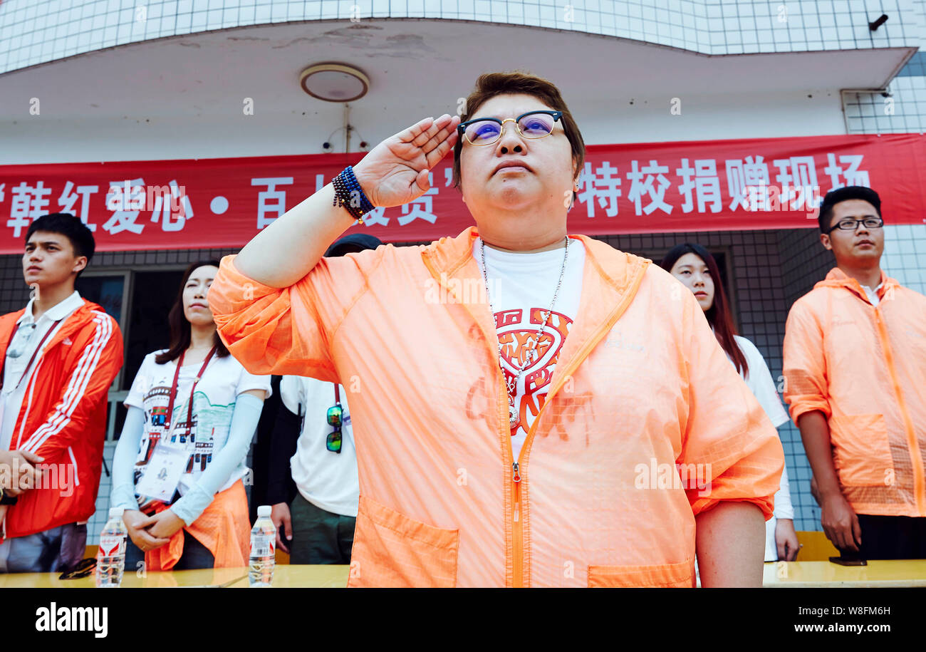 --FILE--Chinese Tibetan singer Han Hong, front, salutes at a donation ...