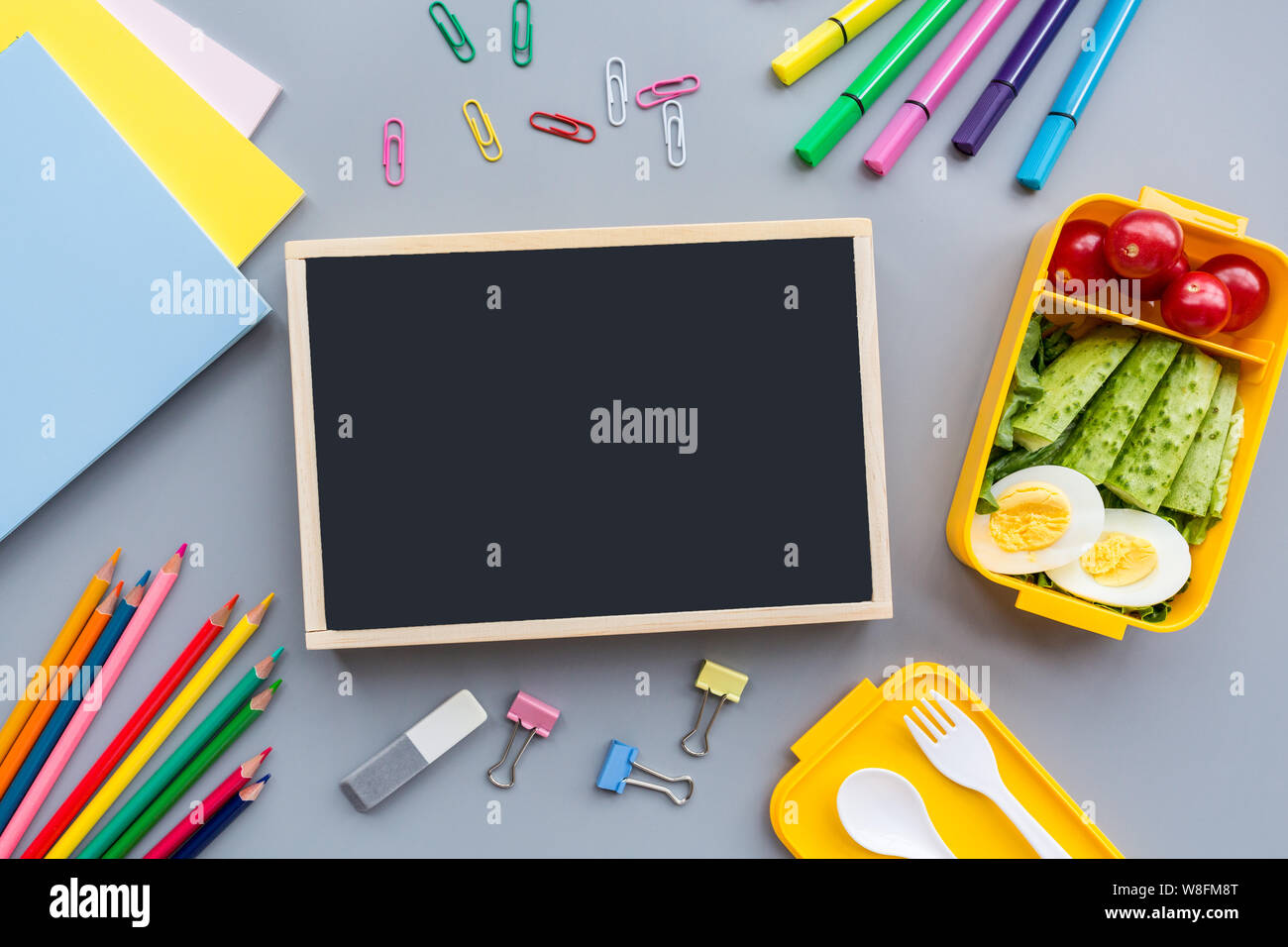 School supplies and lunch box with sandwich and vegetables. Back to ...