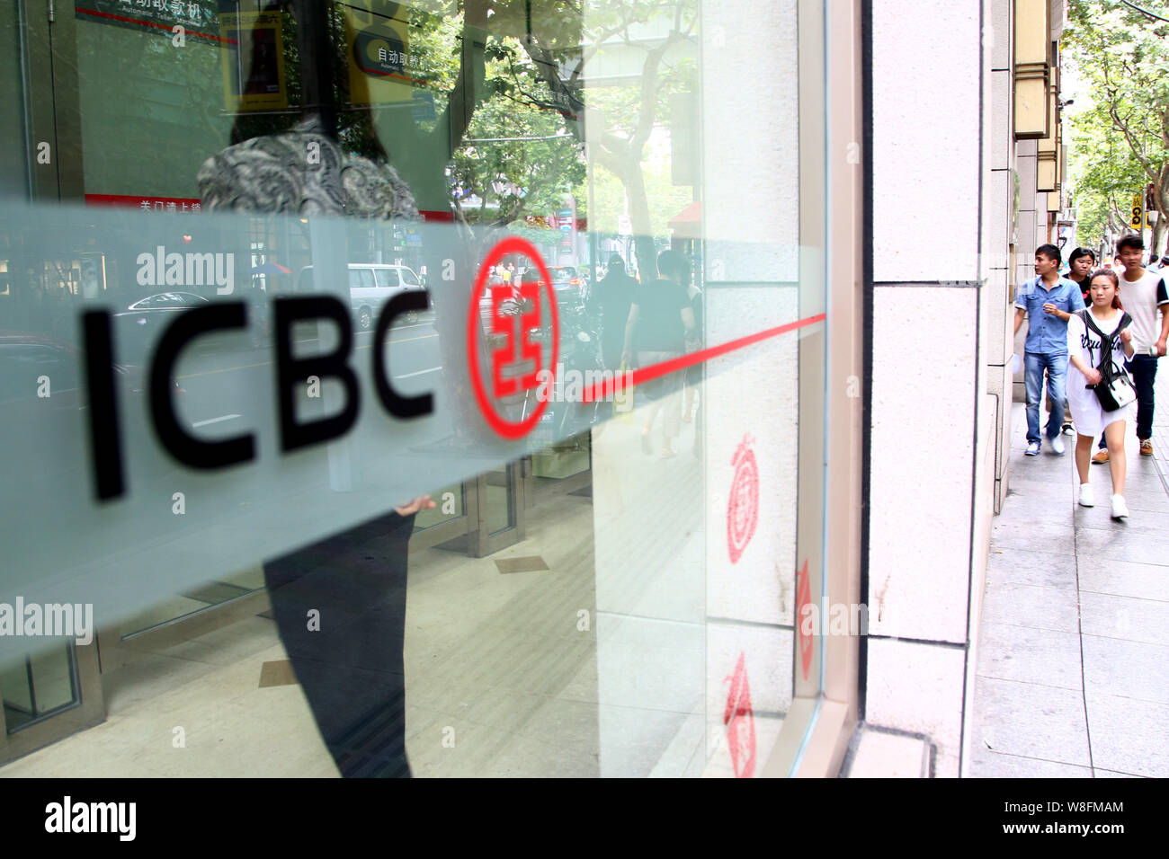 --FILE--Pedestrians walk past a branch of ICBC (Industrial and ...