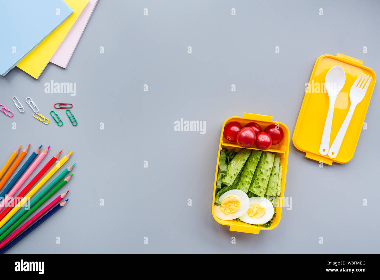 School supplies and lunch box with sandwich and vegetables. Back to ...